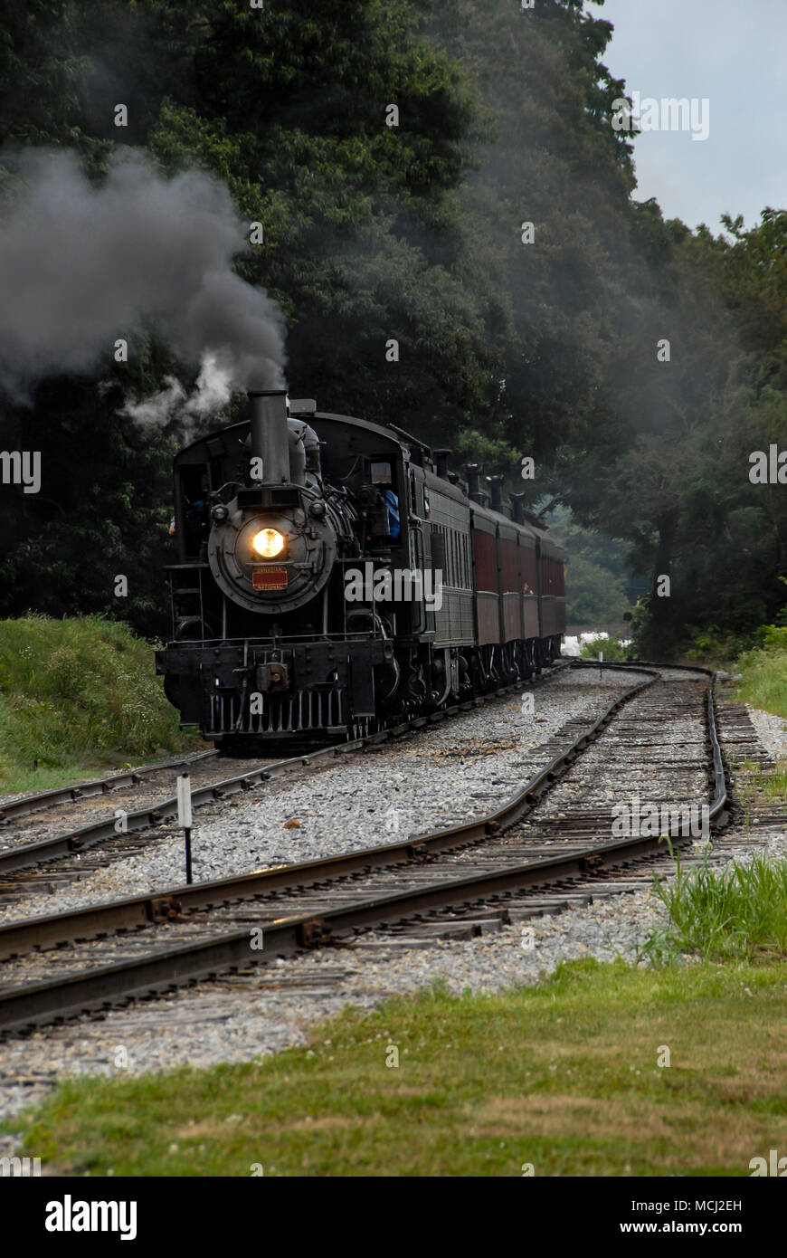 Steam Engine with Passenger Train Pulling into Station Puffing Smoke ...
