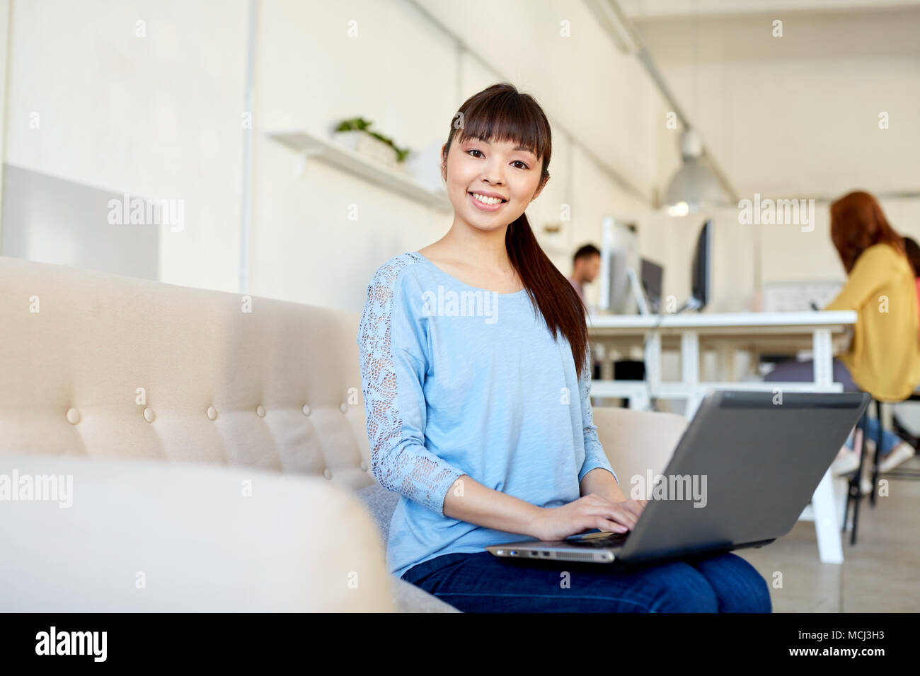 happy asian woman with laptop working at office Stock Photo - Alamy