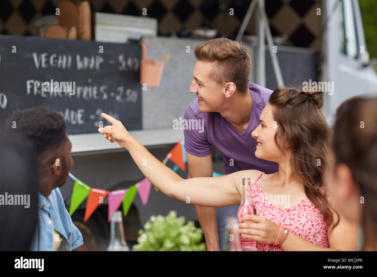 happy customers or friends at food truck Stock Photo - Alamy