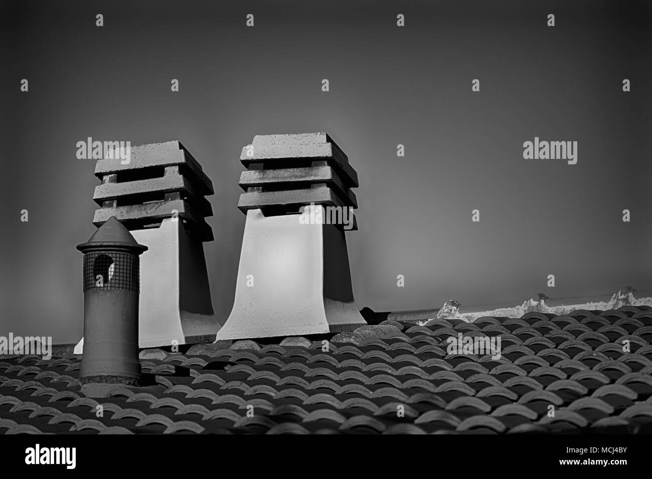 Stone square chimney on the roof in sunny weather Stock Photo - Alamy