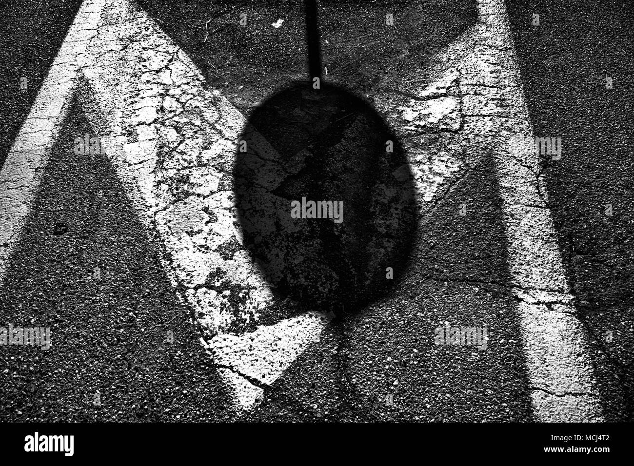 Shadow street sign on asphalt road, urban background Stock Photo - Alamy
