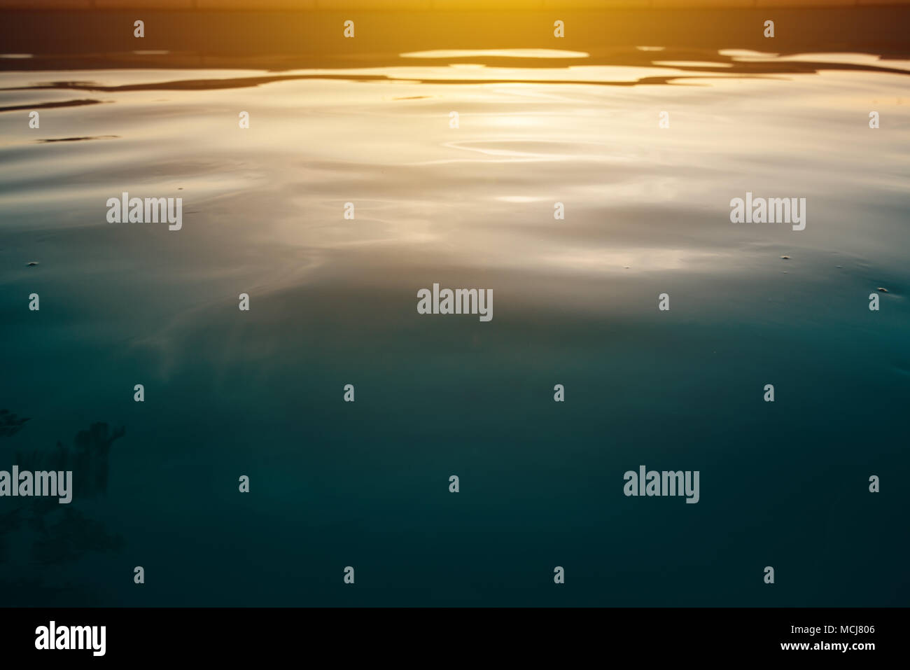 Outdoor swimming pool. Refreshing blue poolside water in summer sunset ...