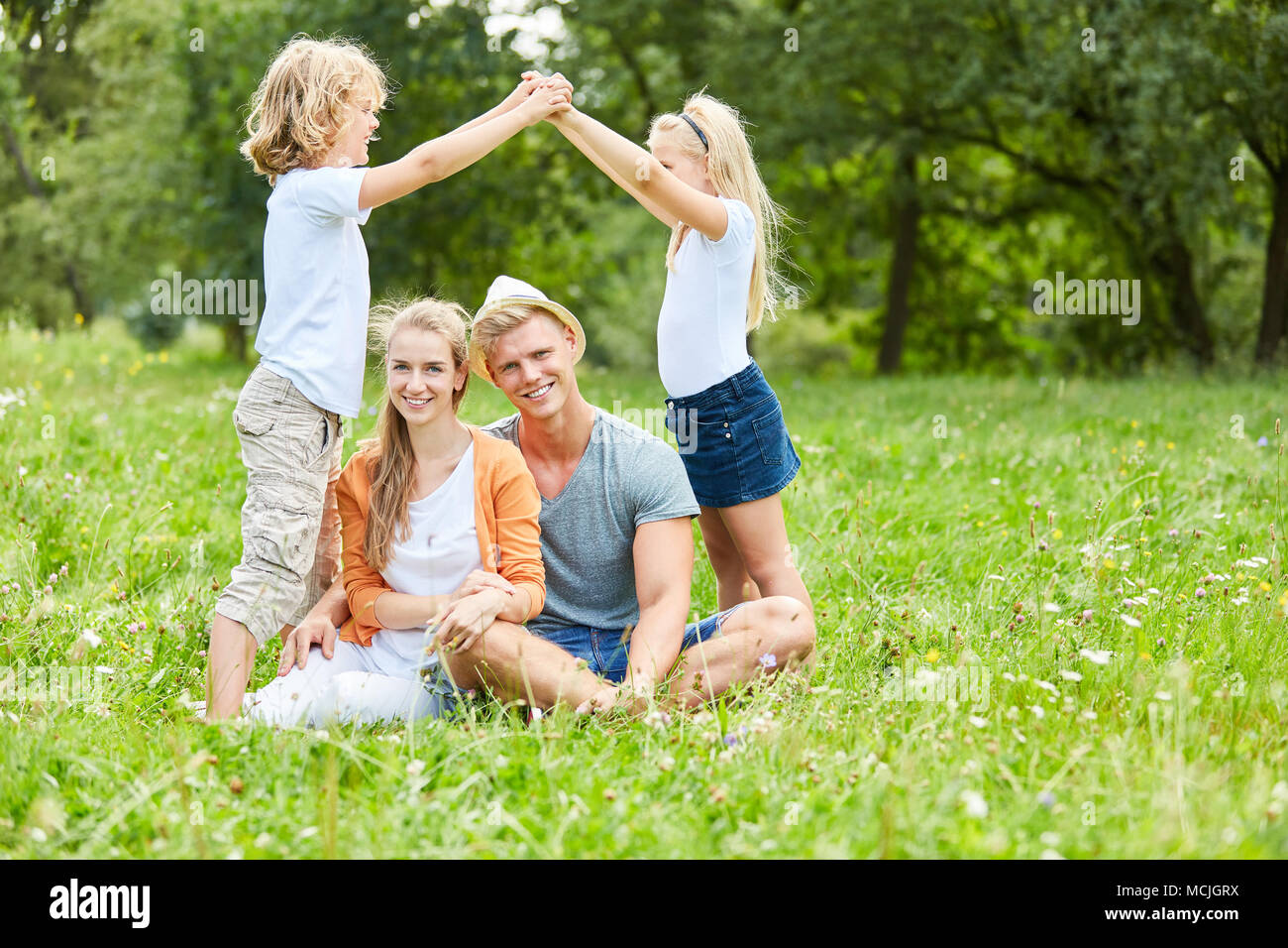 Children build a roof with their hands as a sign of a home Stock Photo ...