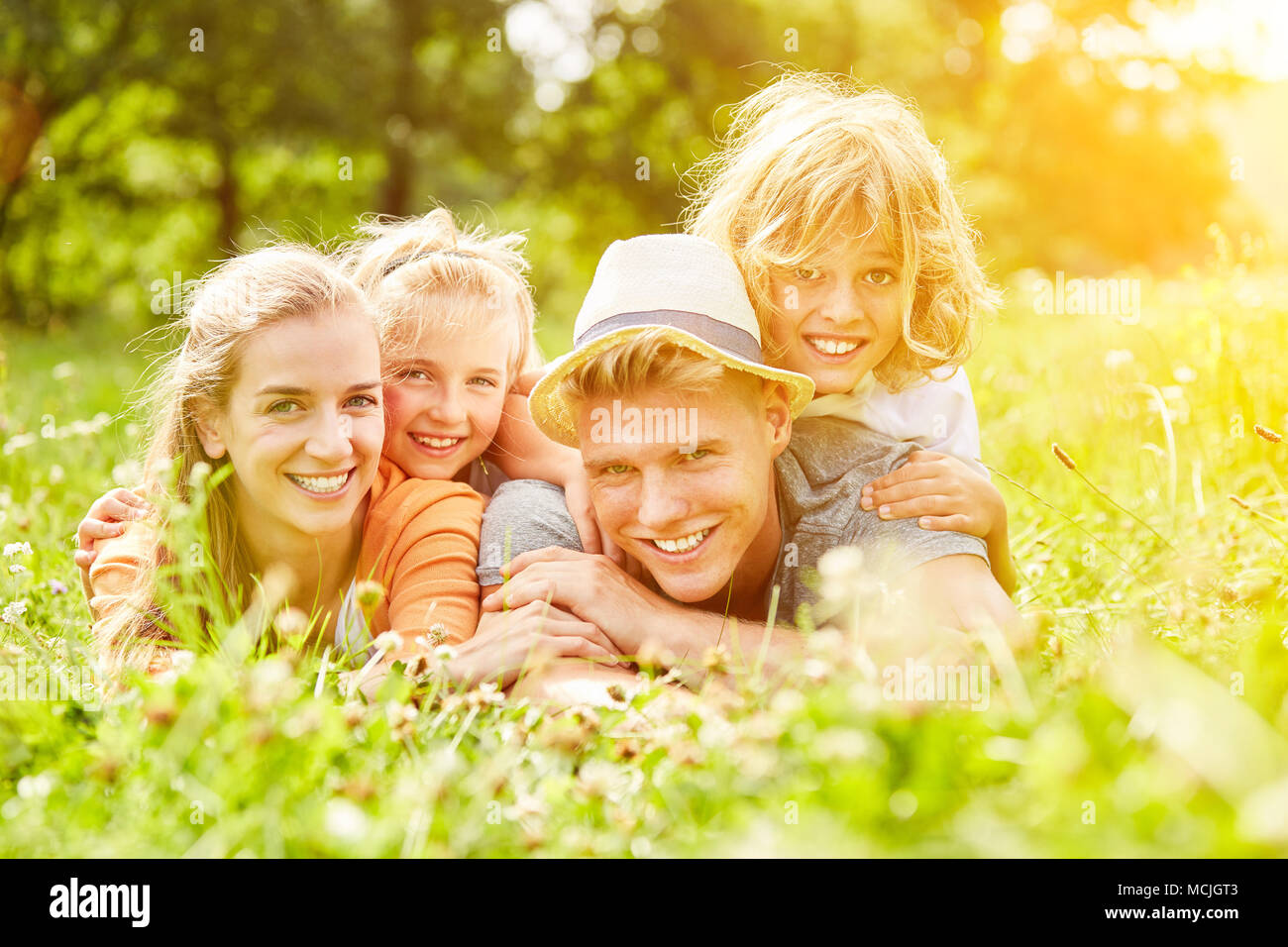 Relaxed family and children lie in a meadow on a summer vacation Stock ...