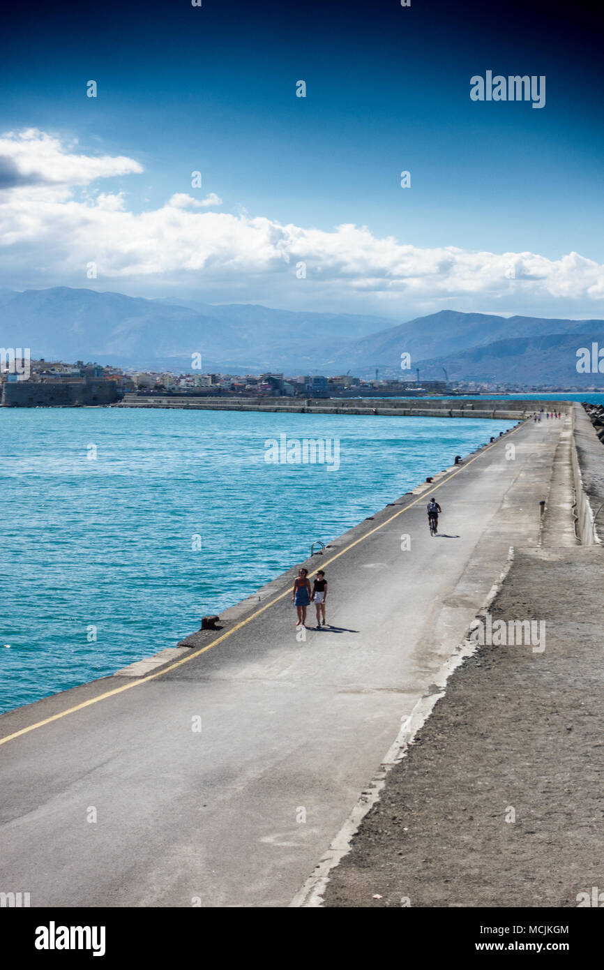 Long jetty on sea with mountain in the background, Heraklion, Greece ...