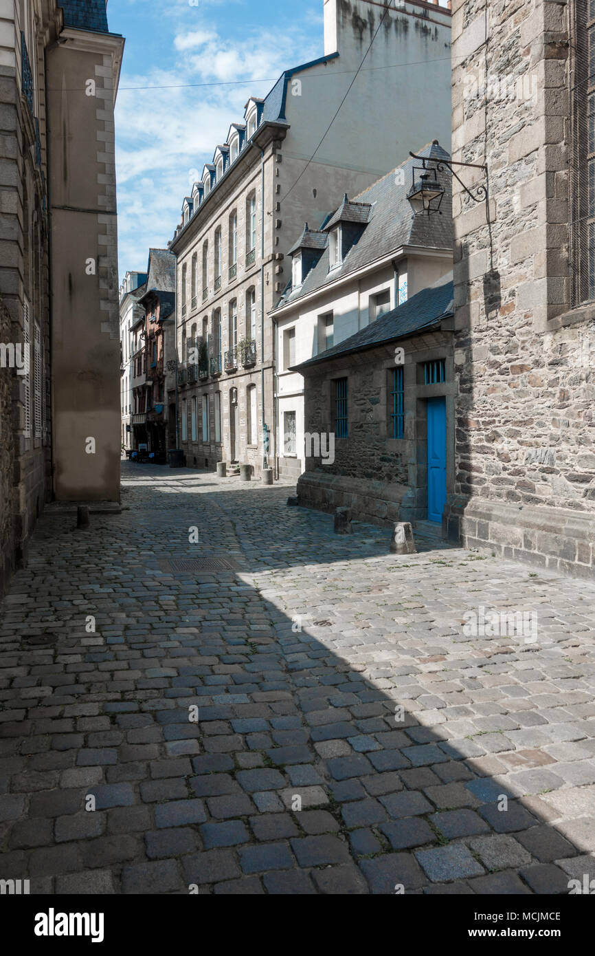 View of cobblestone alley in between residential buildings, Brittany ...