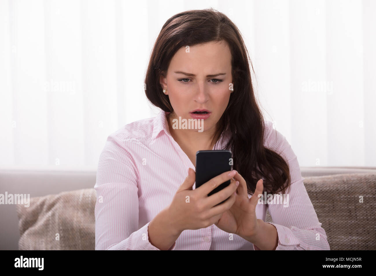 Person shocked at phone hi-res stock photography and images - Alamy
