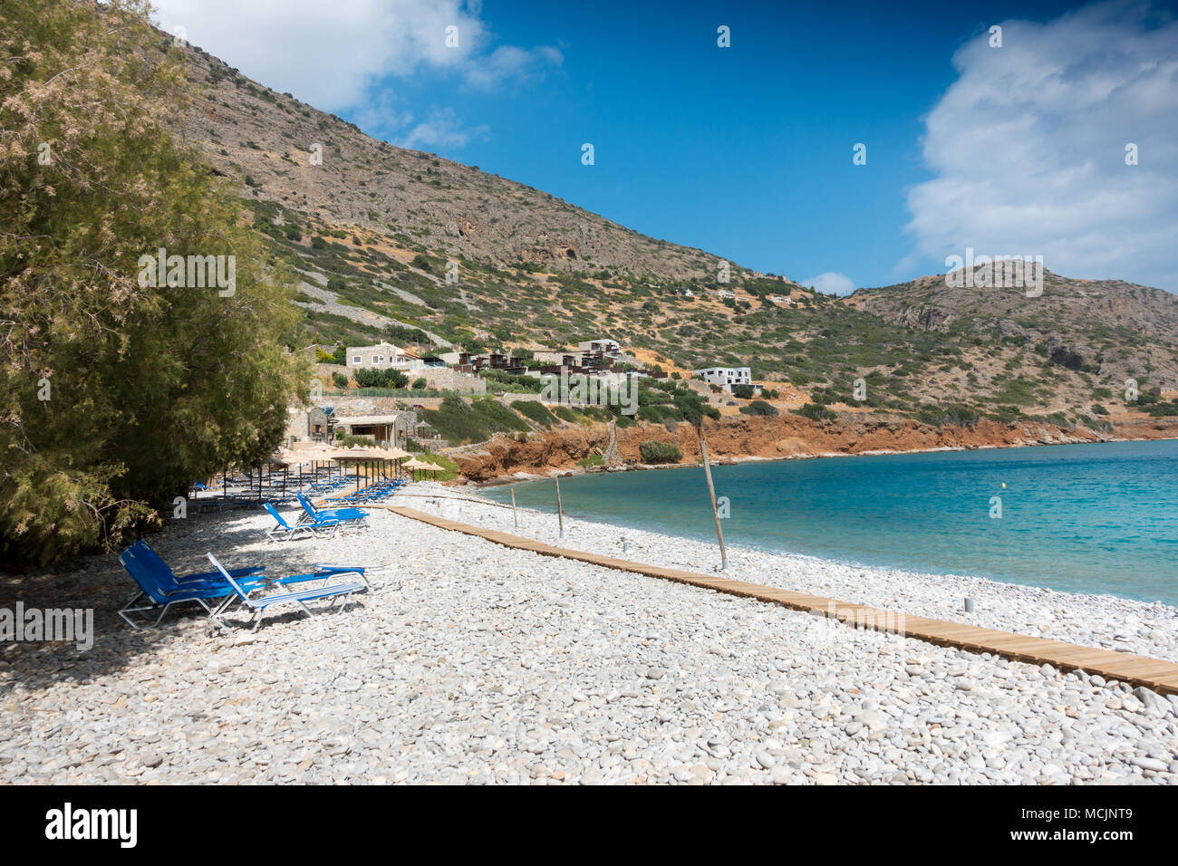 Deckchairs on beach in Spinalonga, Crete, Greece Stock Photo - Alamy