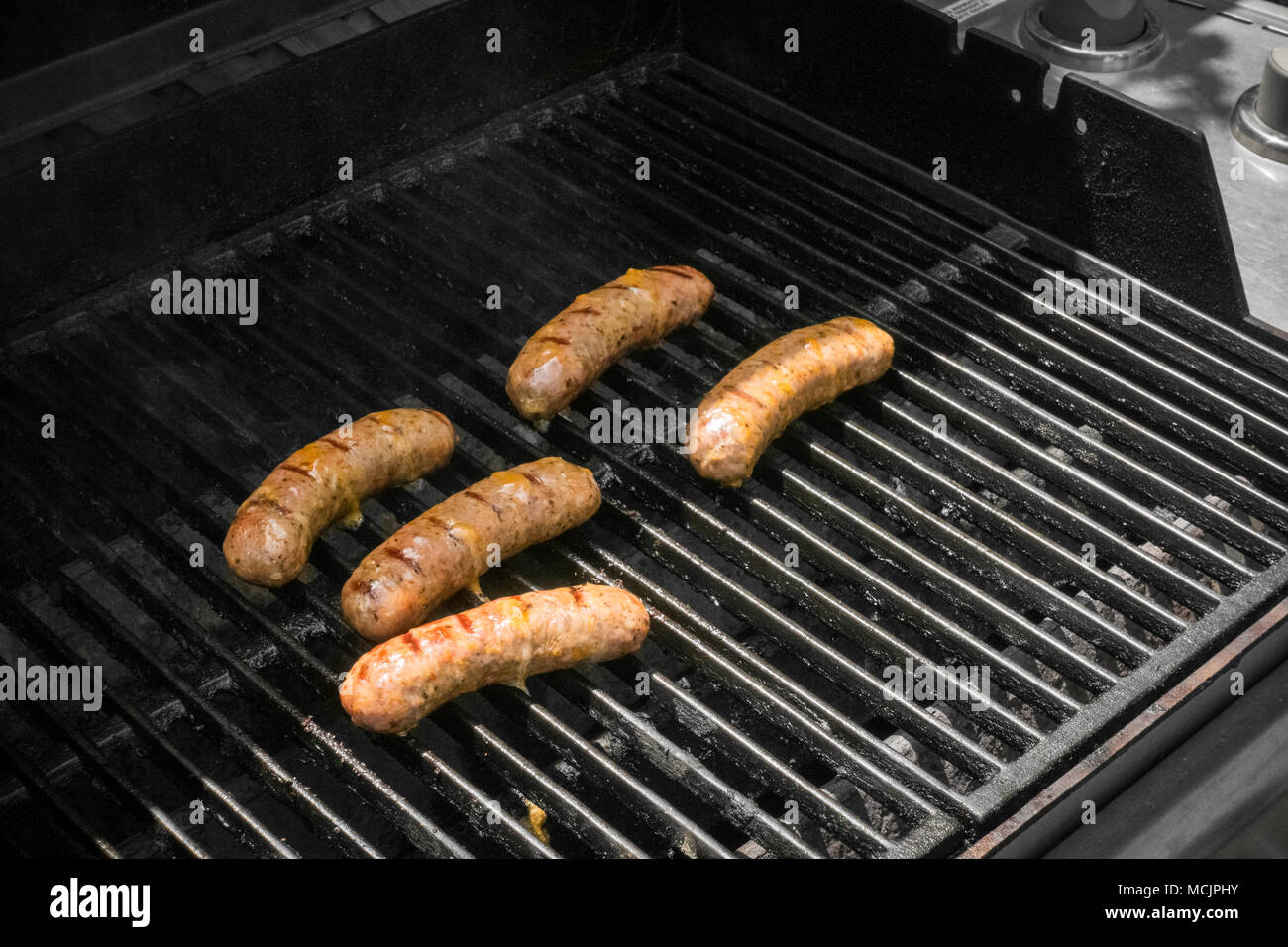 Sausage being cooked on grill Stock Photo - Alamy