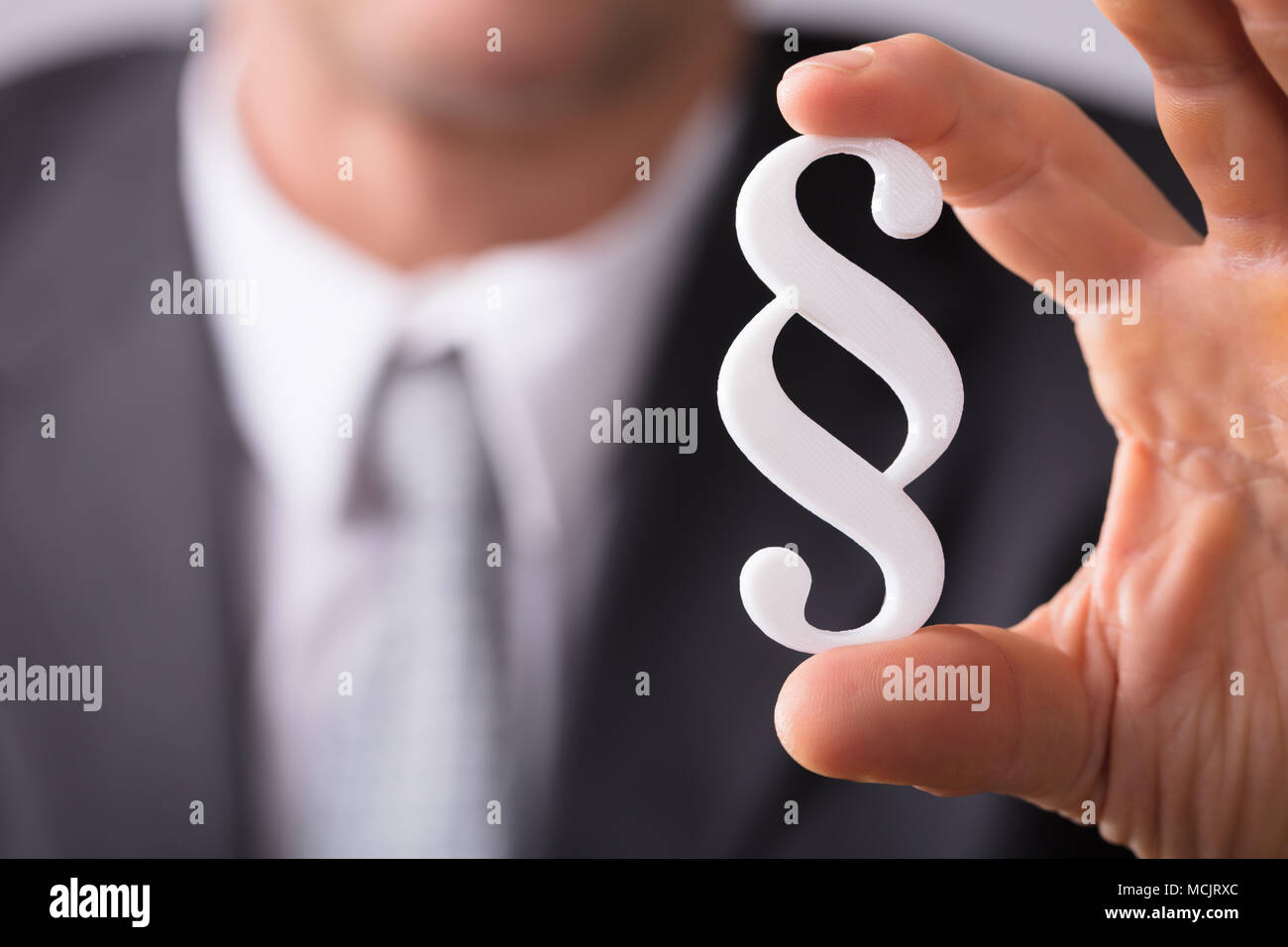 Close-up Of A Businessperson's Hand Holding Paragraph Symbol Stock ...