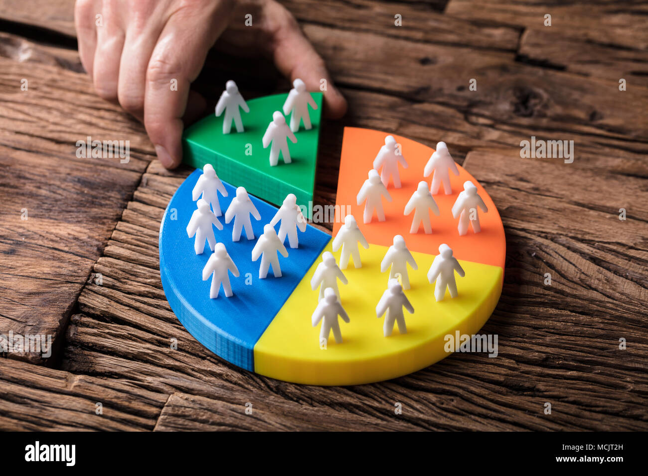 Human Hand Placing A Last Piece With Human Figures Into Pie Chart On ...