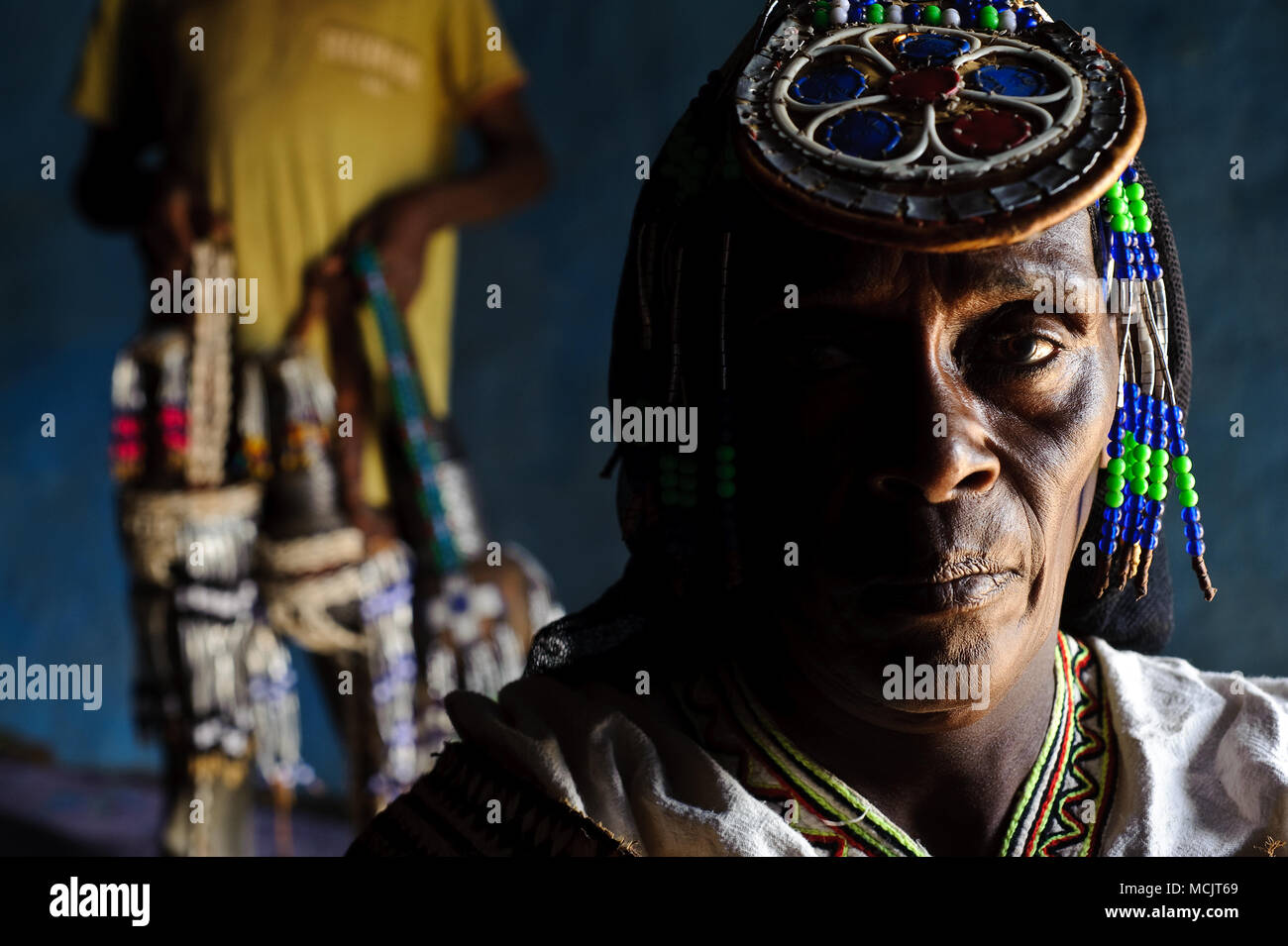 Guji woman in traditional dress + decorated water containers in the ...