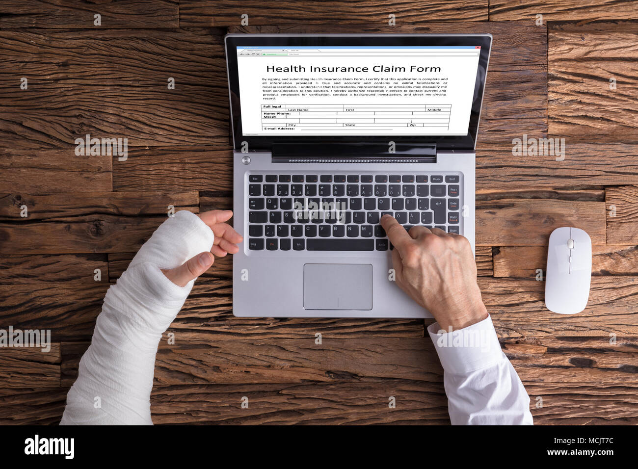 High Angle View Of A Businessperson With Hand Injury Filling Health ...
