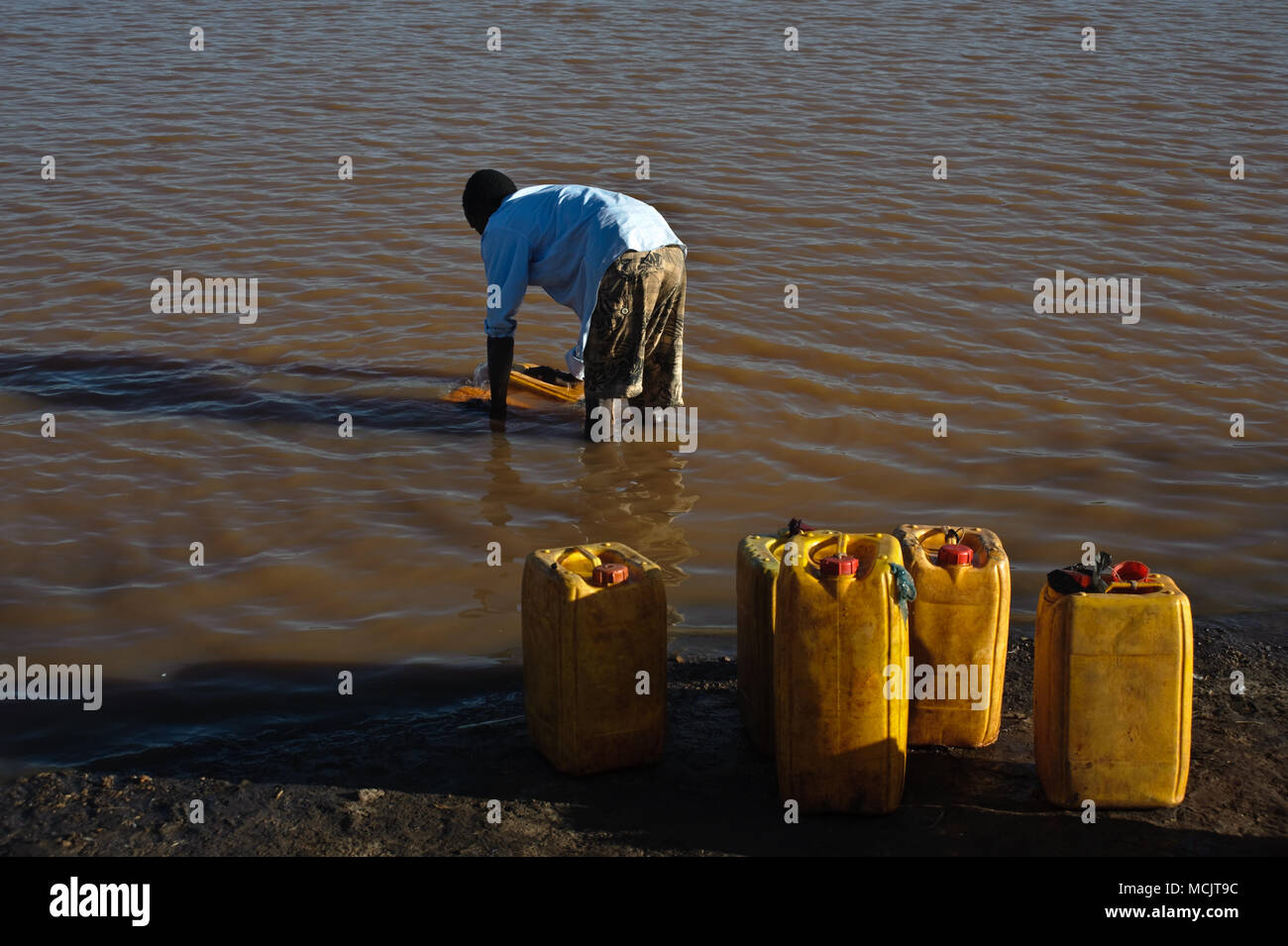 Man fetching water hi-res stock photography and images - Alamy