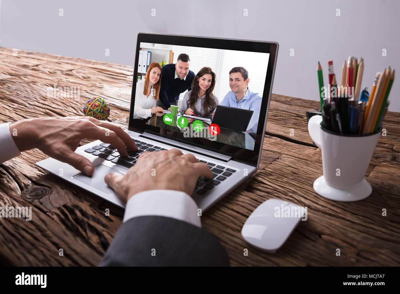 Close-up Of A Businessperson's Hand Video Conferencing With Colleague ...