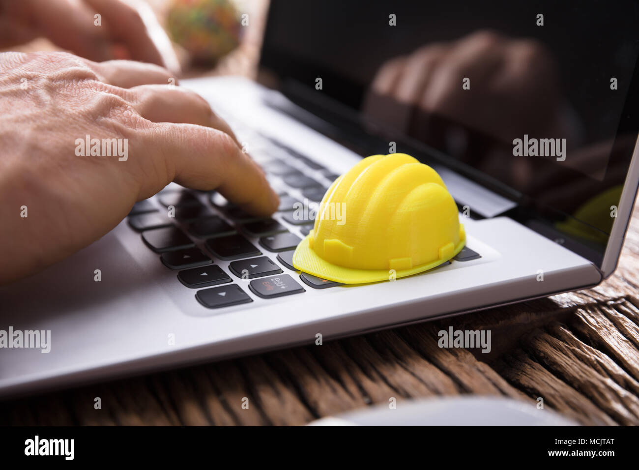 Close-up Of An Architecture's Hand Using Laptop With Yellow Hard Hat On ...