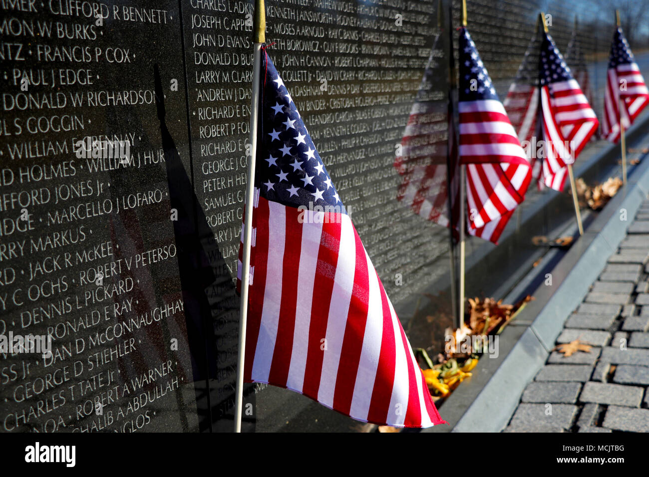 A row of flags at a monument to honor fallen soldiers Stock Photo - Alamy