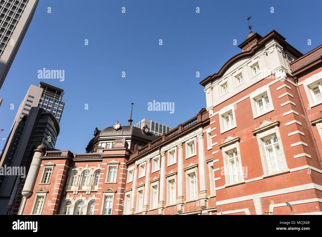 The classic architecture of the Tokyo JR train station contrasts with ...