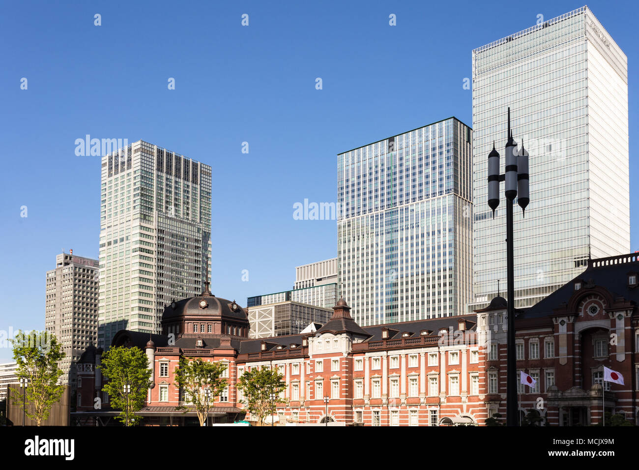 The classic architecture of the Tokyo JR train station contrasts with ...