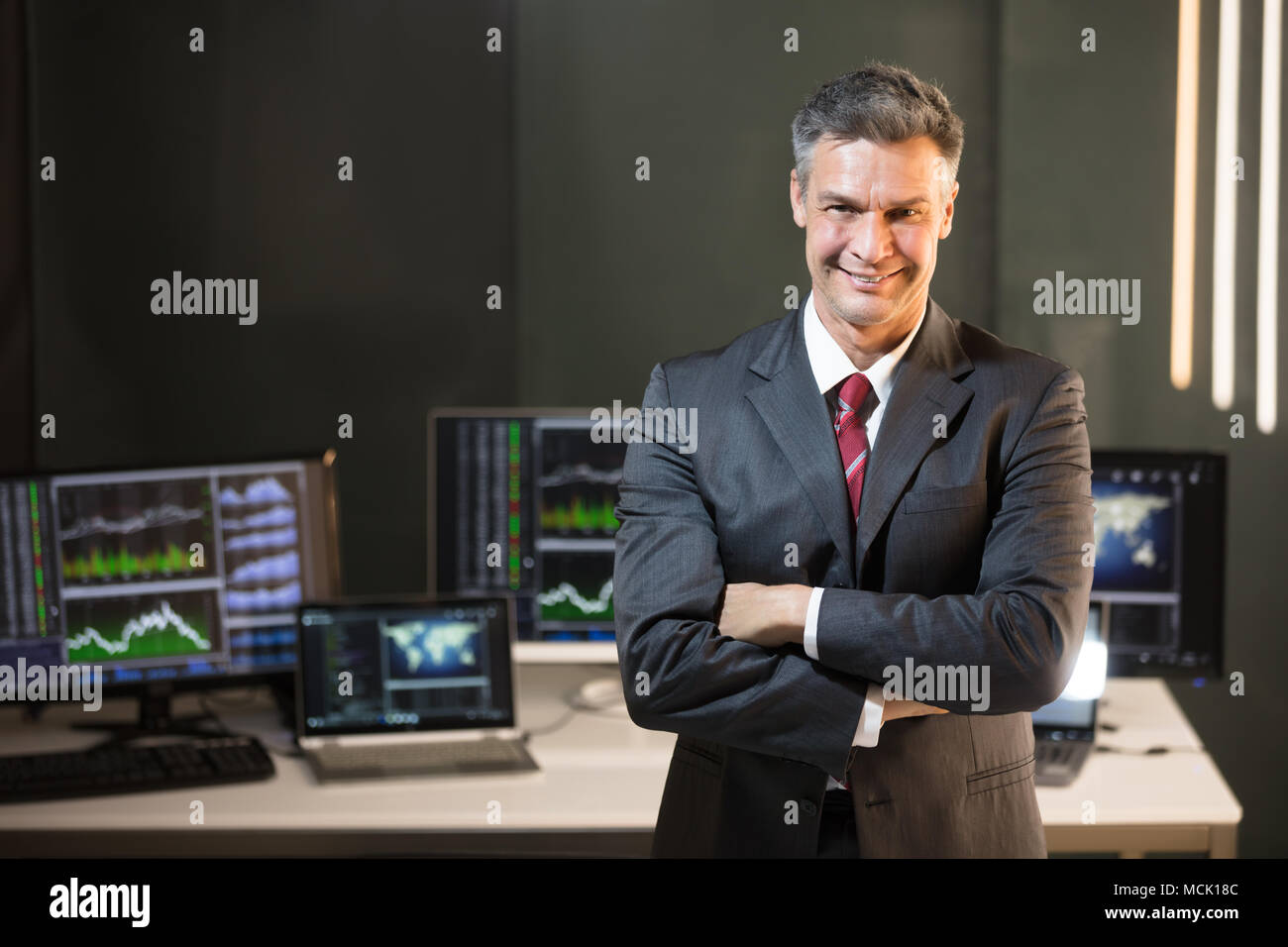 Portrait Of A Male Stock Market Broker With Folded Arms Stock Photo - Alamy