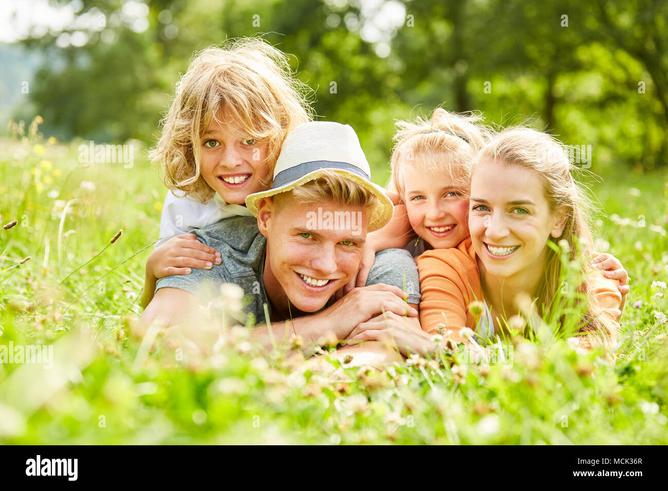 Parents and children are happy and relaxed together in the grass Stock ...