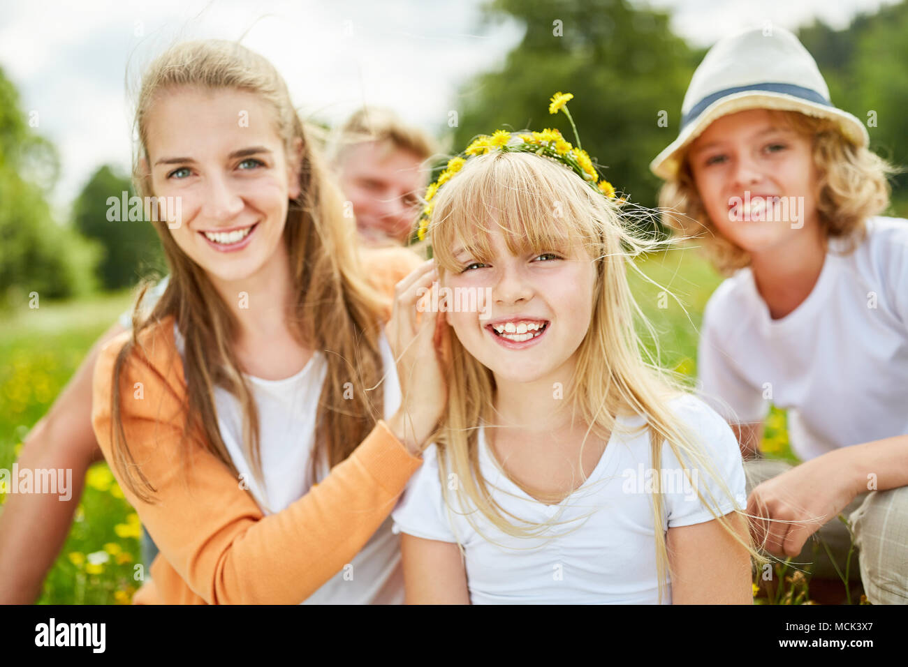 Happy girl with yellow flowers in hair in spring or summer Stock Photo ...