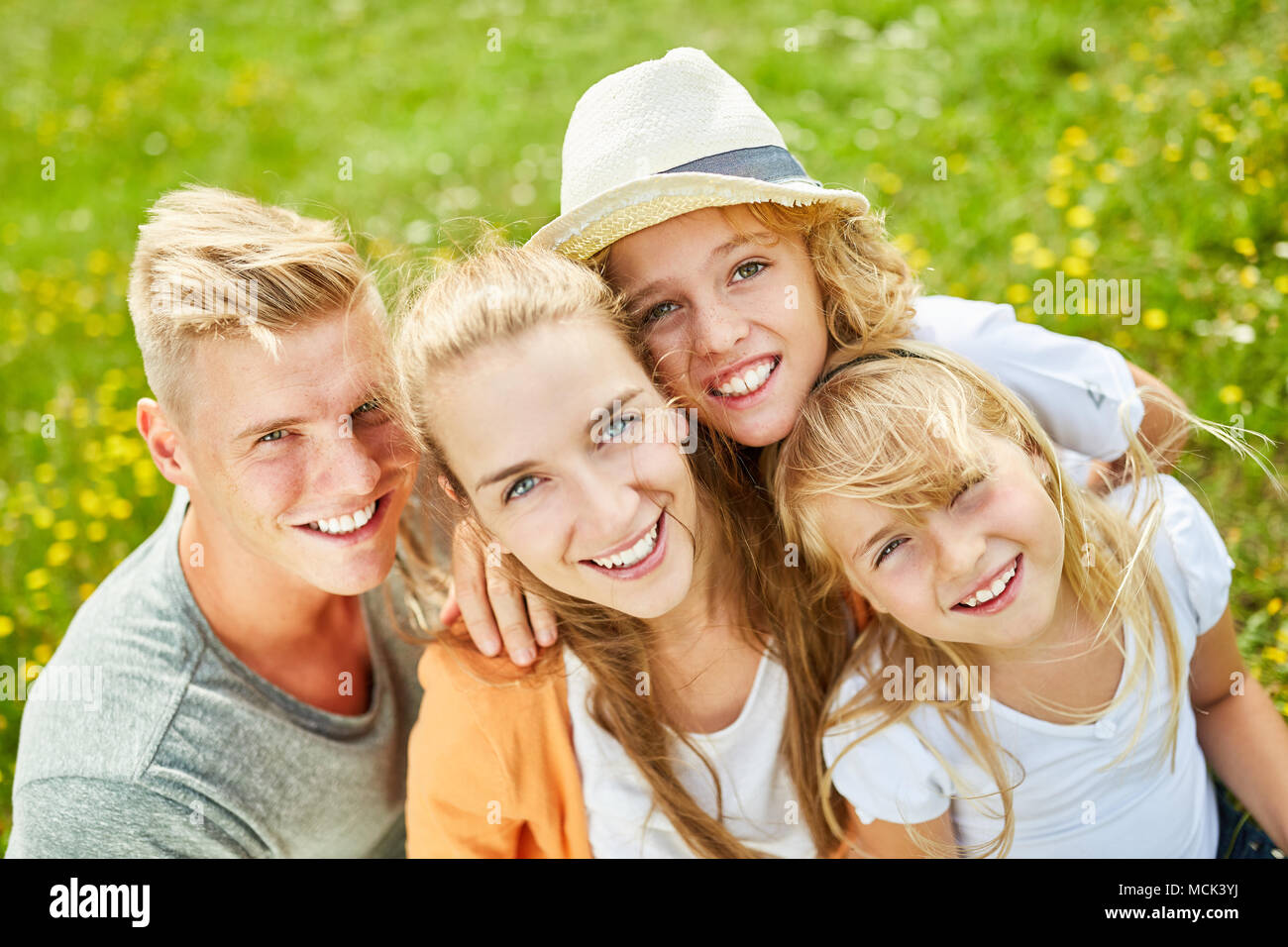 Happy family and two kids in the garden in summer Stock Photo - Alamy