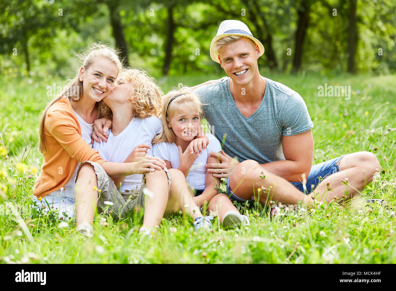 Happy family with two kids in the summer in the garden Stock Photo - Alamy