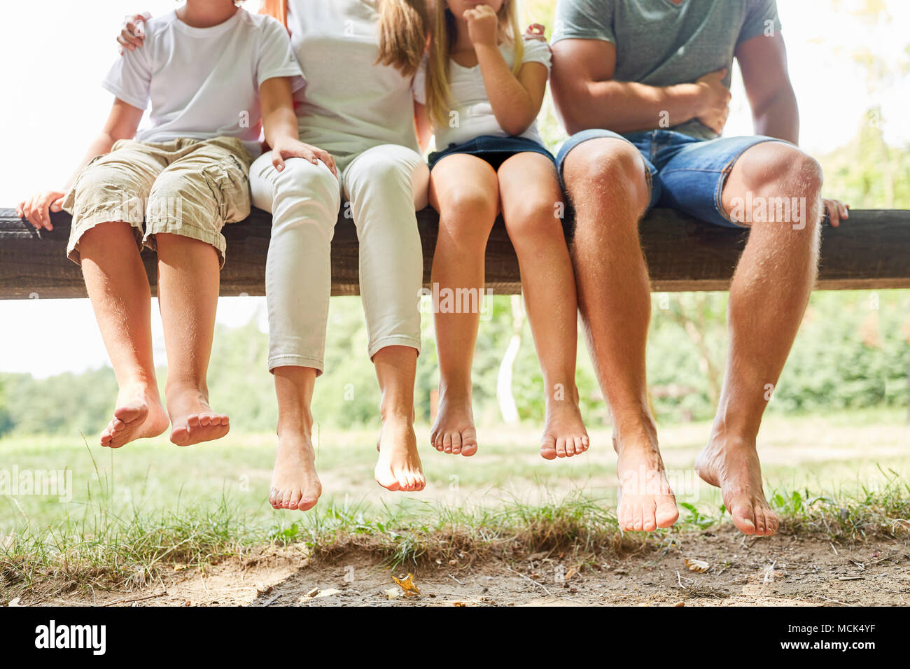 Happy family and children take rest on a park bench Stock Photo - Alamy