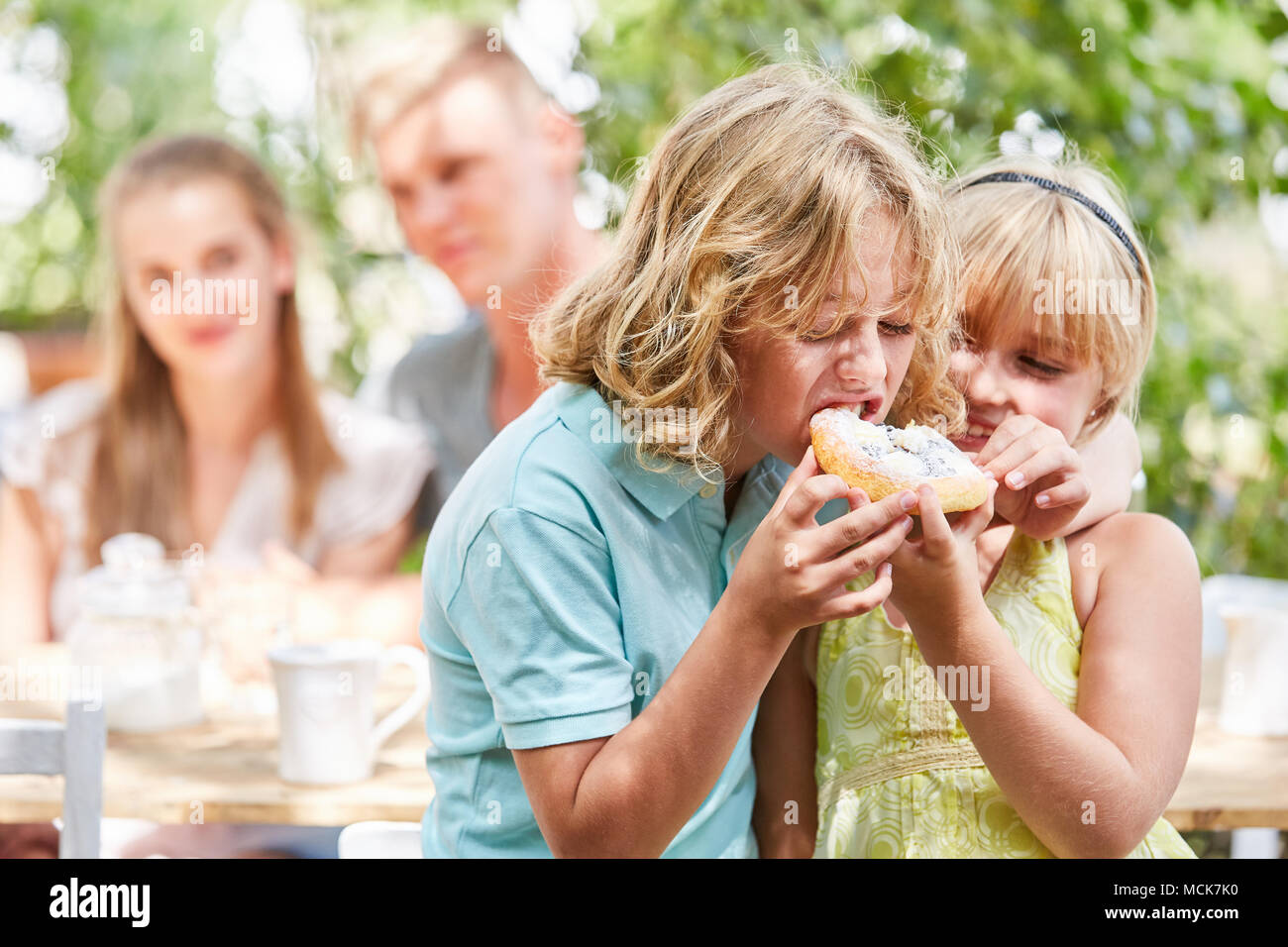 Sibling couple sharing a delicious piece of cake full of enjoyment ...