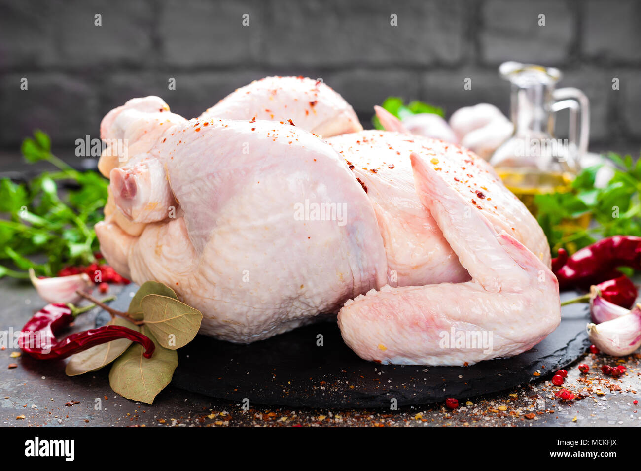 Raw chicken. Fresh whole chicken with ingredients for cooking Stock ...