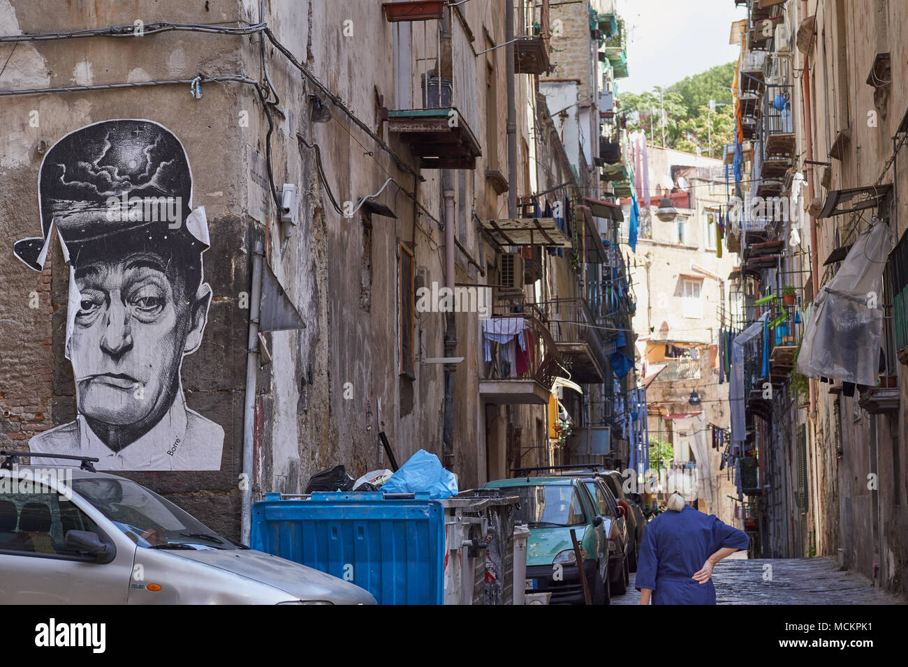 Typical street scene in downtown Napoli with a mural of famous comedian ...