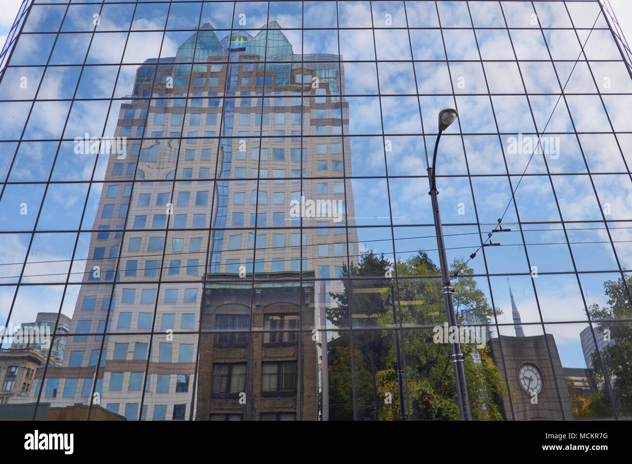 Reflections of an office tower in Hamilton Street, Vancouver downtown ...