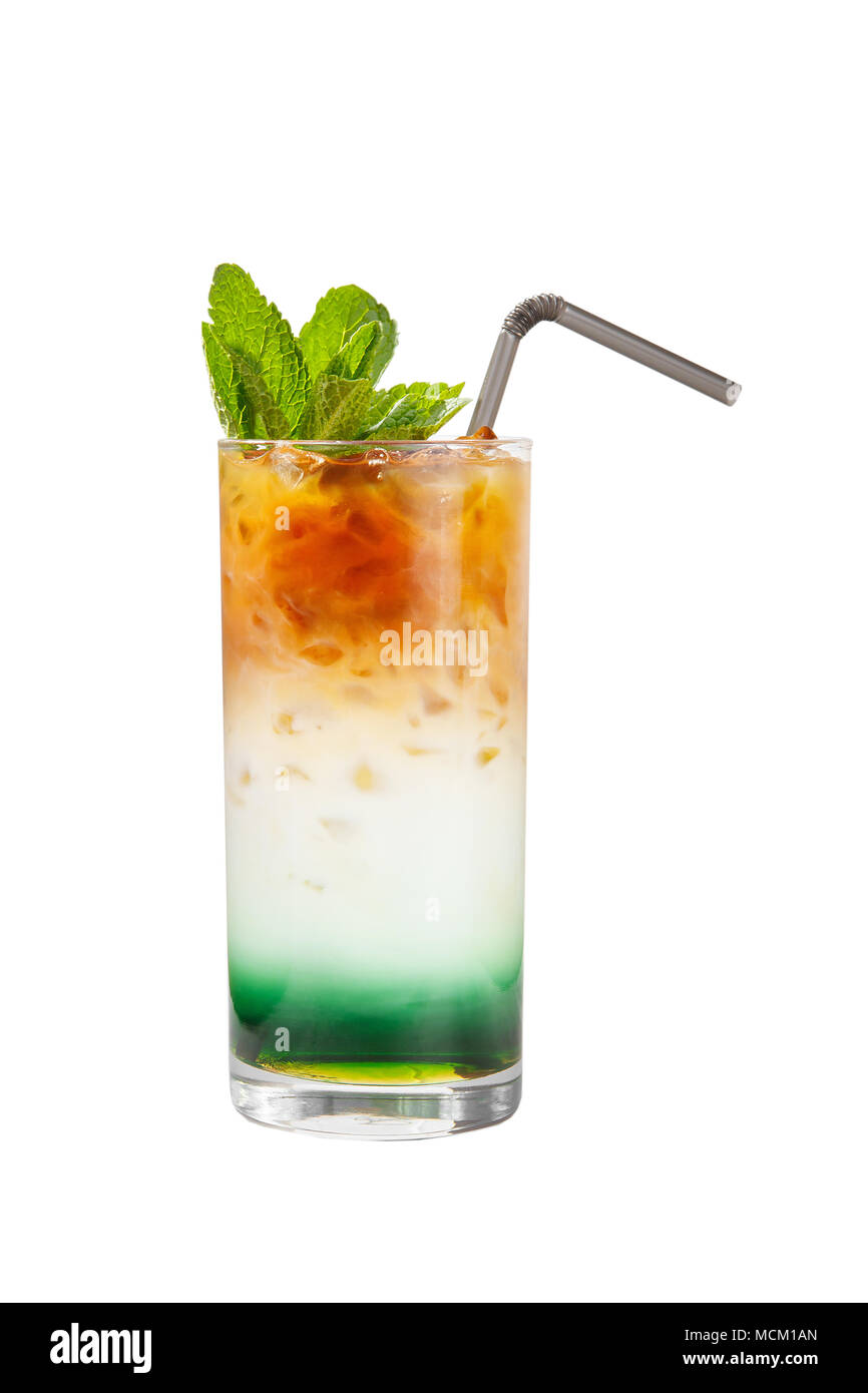 A multi-colored, three-layered cocktail in glass with crushed ice and ...