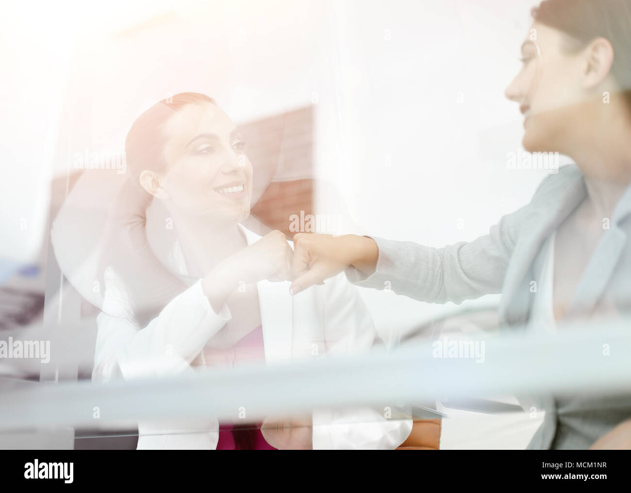 behind the glass.colleagues celebrate their success Stock Photo - Alamy