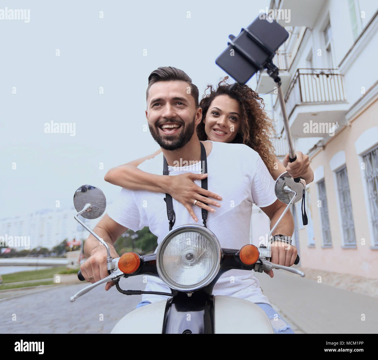 Happy couple on scooter making selfie on smartphone outdoor Stock Photo ...