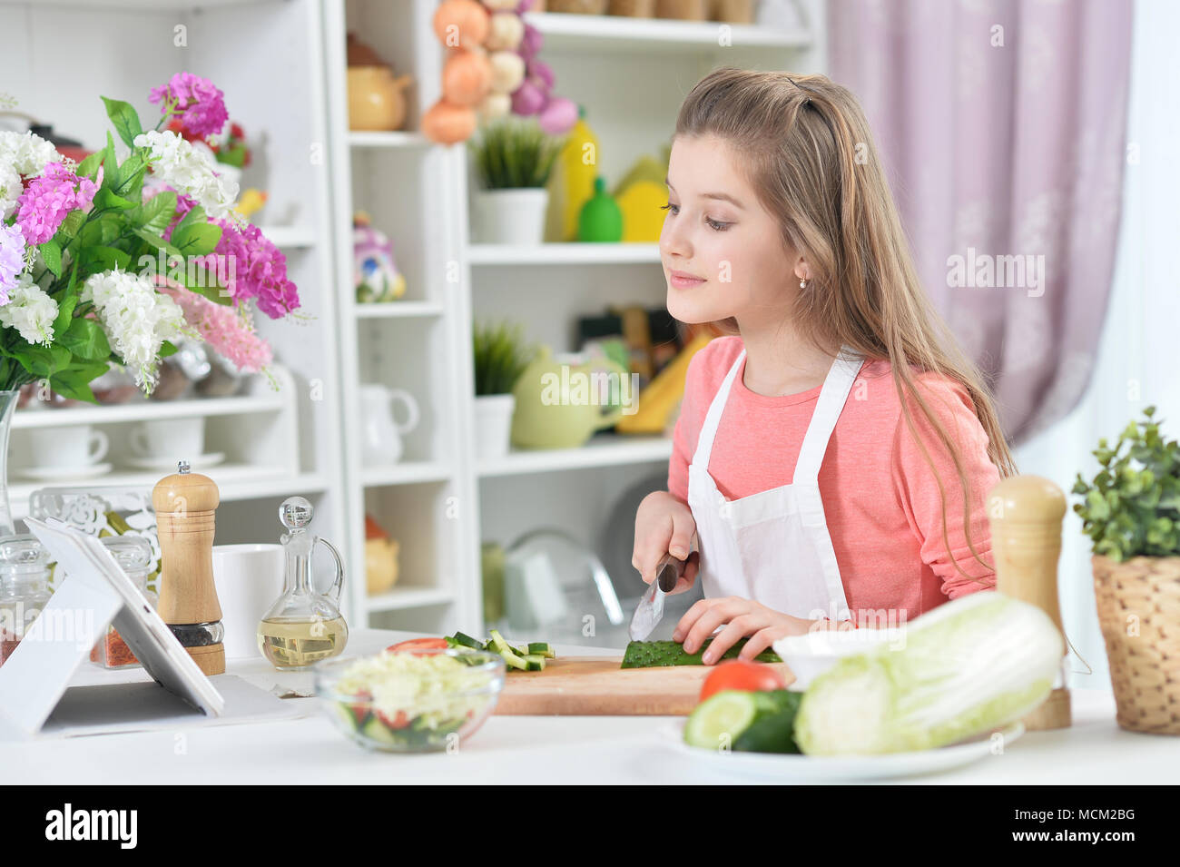 attractive young girl cooking Stock Photo - Alamy