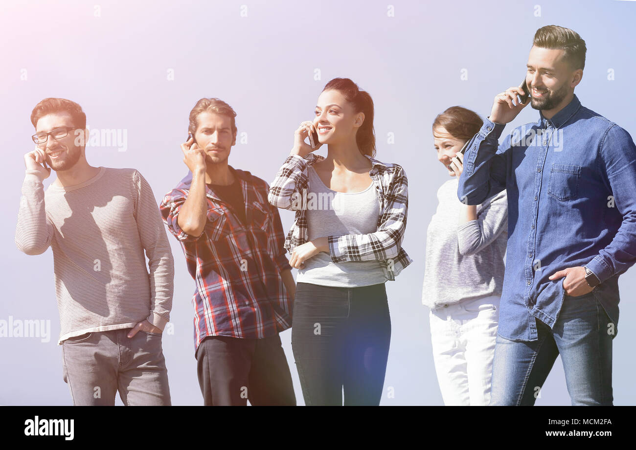 group of students talking on their smartphones Stock Photo - Alamy