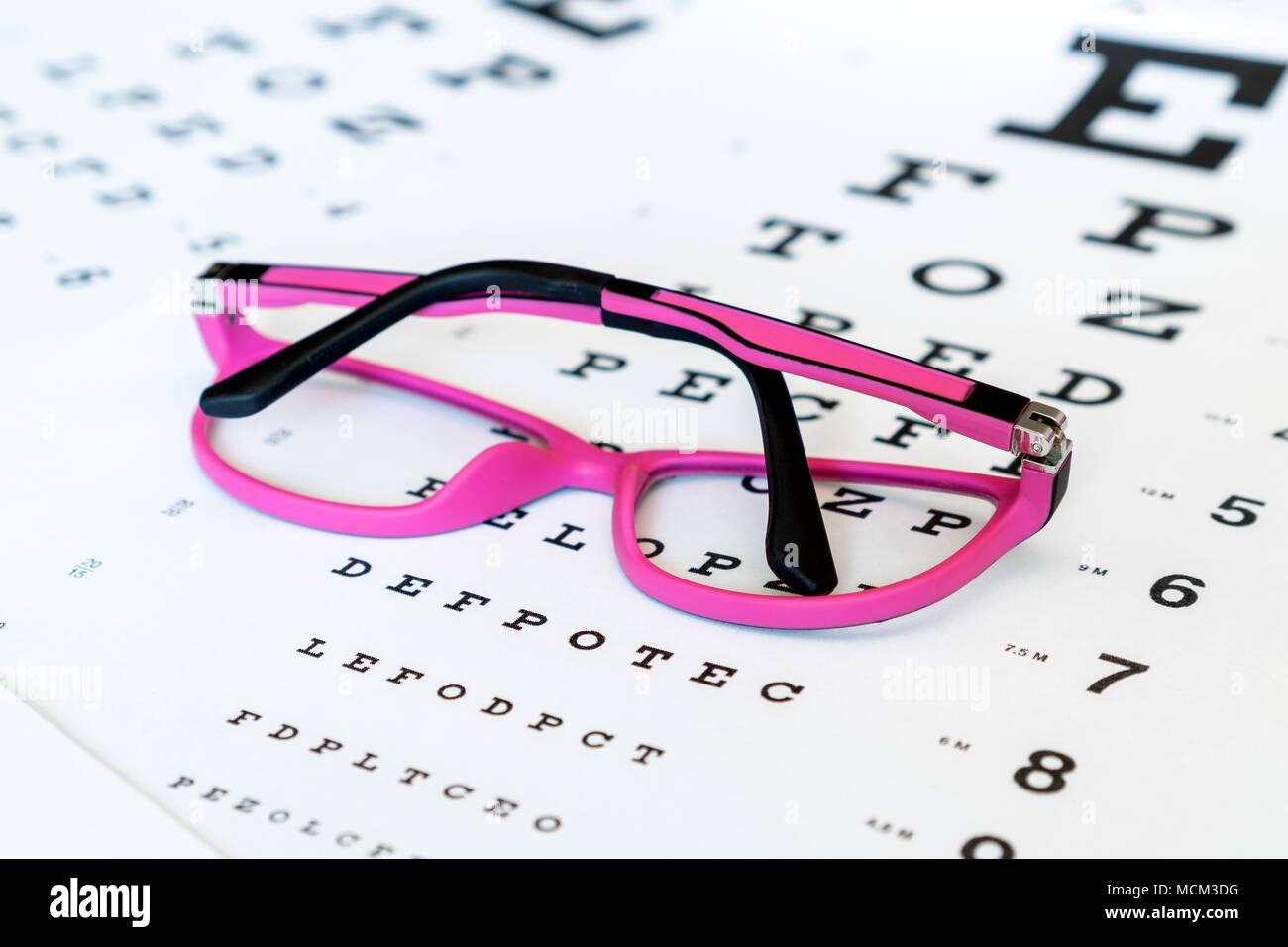 Pink glasses on a eye exam chart to test eyesight accuracy Stock Photo ...