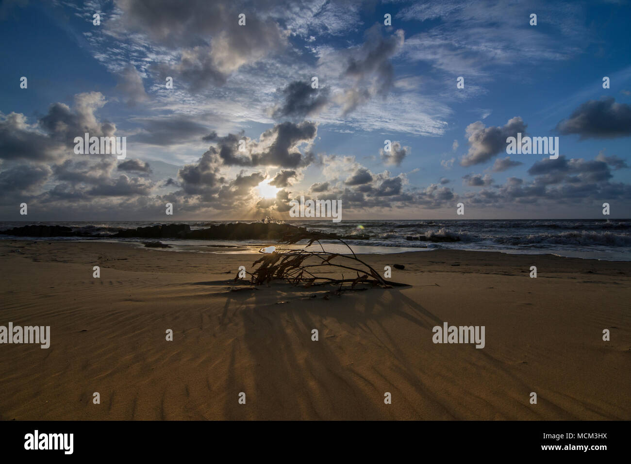 The sun behind the dark clouds, creating breathtaking ray of lights to ...
