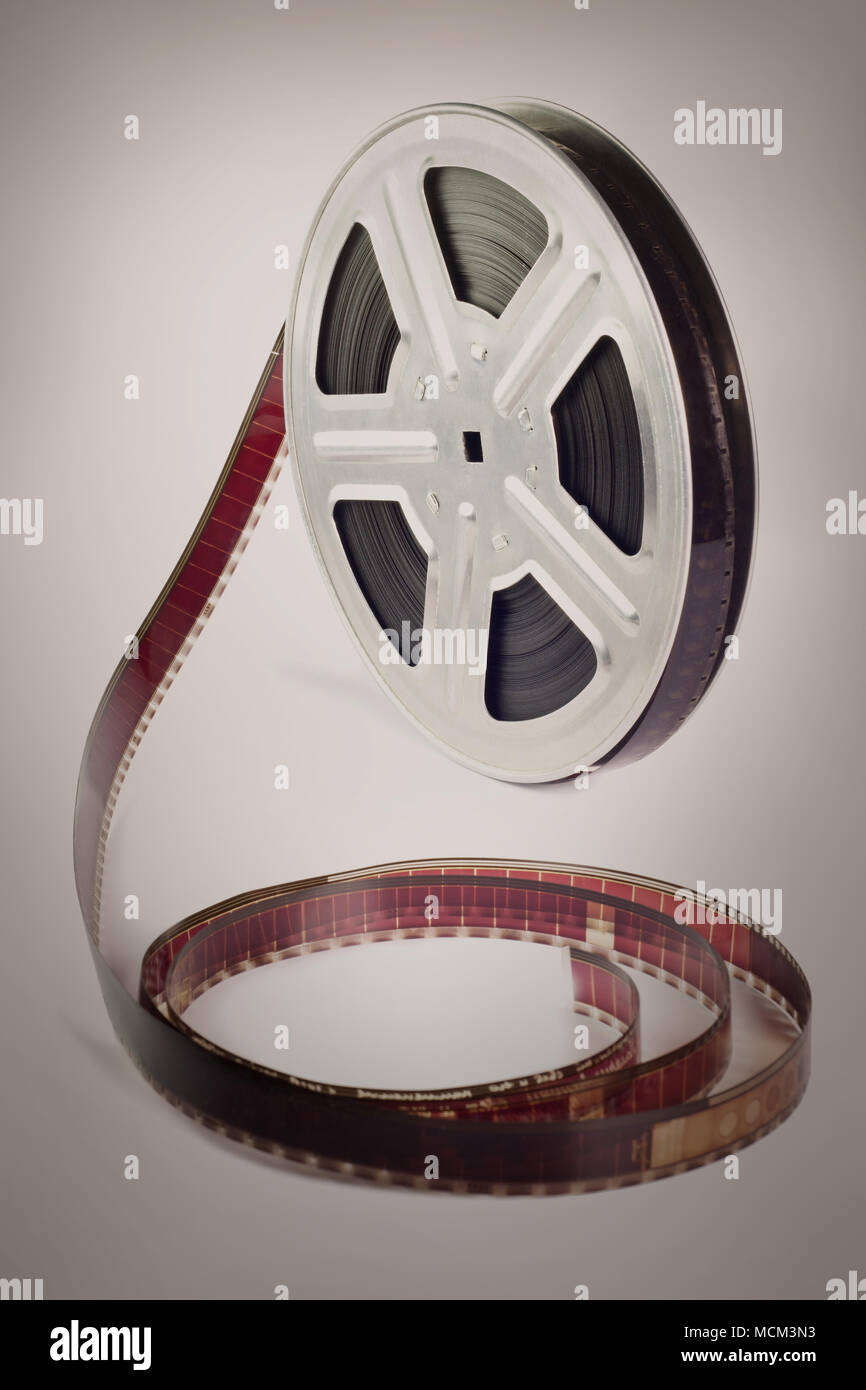 Old motion picture film reel on brown background Stock Photo - Alamy