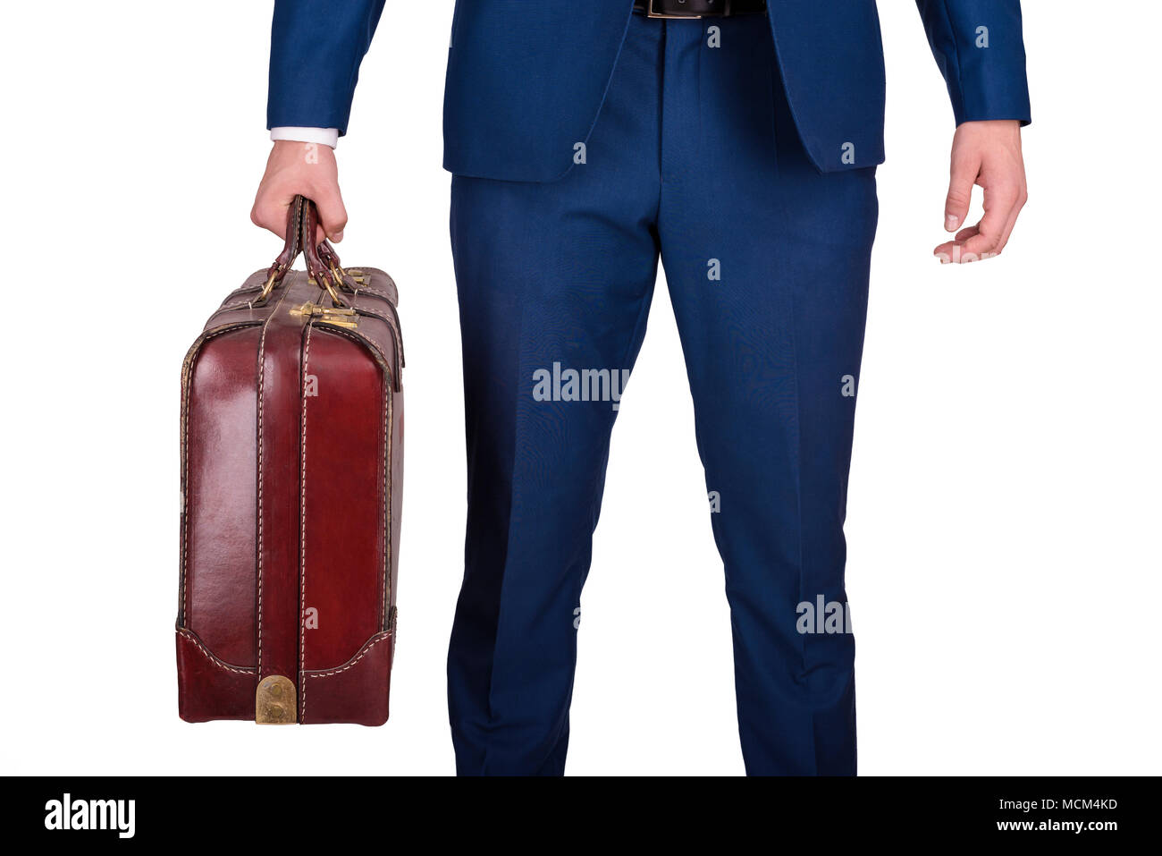 Businessman holding suitcase in hand, isolated over white background ...
