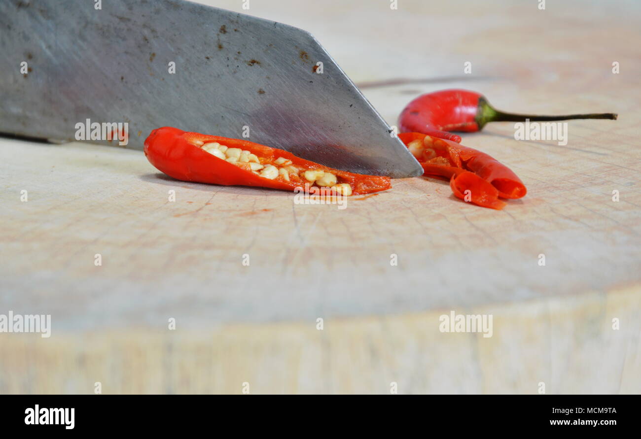 knife cut red chili on chop block Stock Photo - Alamy