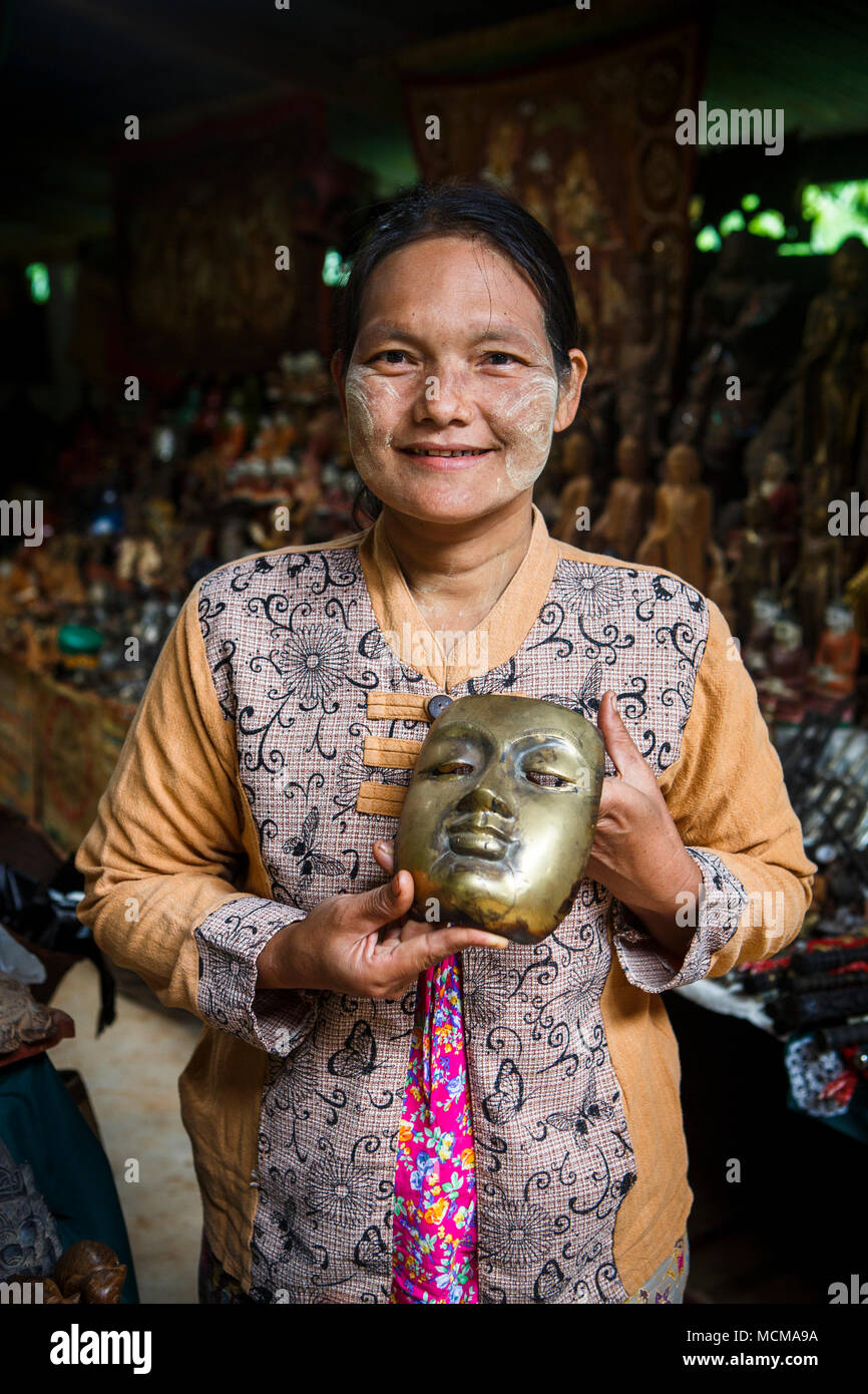 Portrait of female crafts vendor selling masks at temple complex near ...