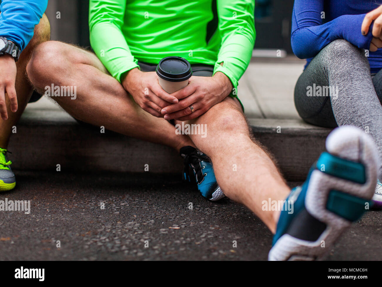Man drinking coffee while taking break while jogging, Seattle ...