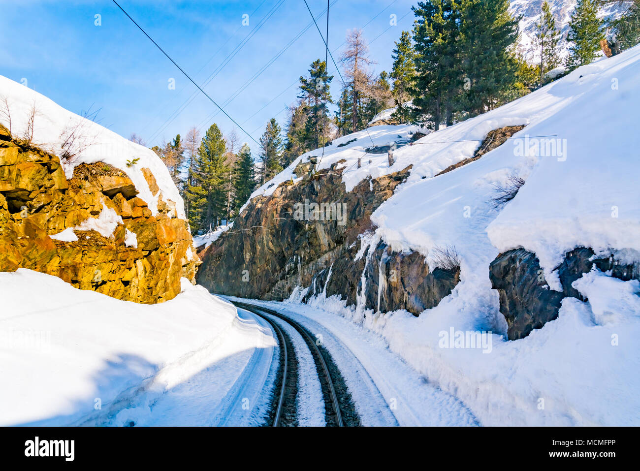 View of railway track and big rocks covered with snow in countryside ...