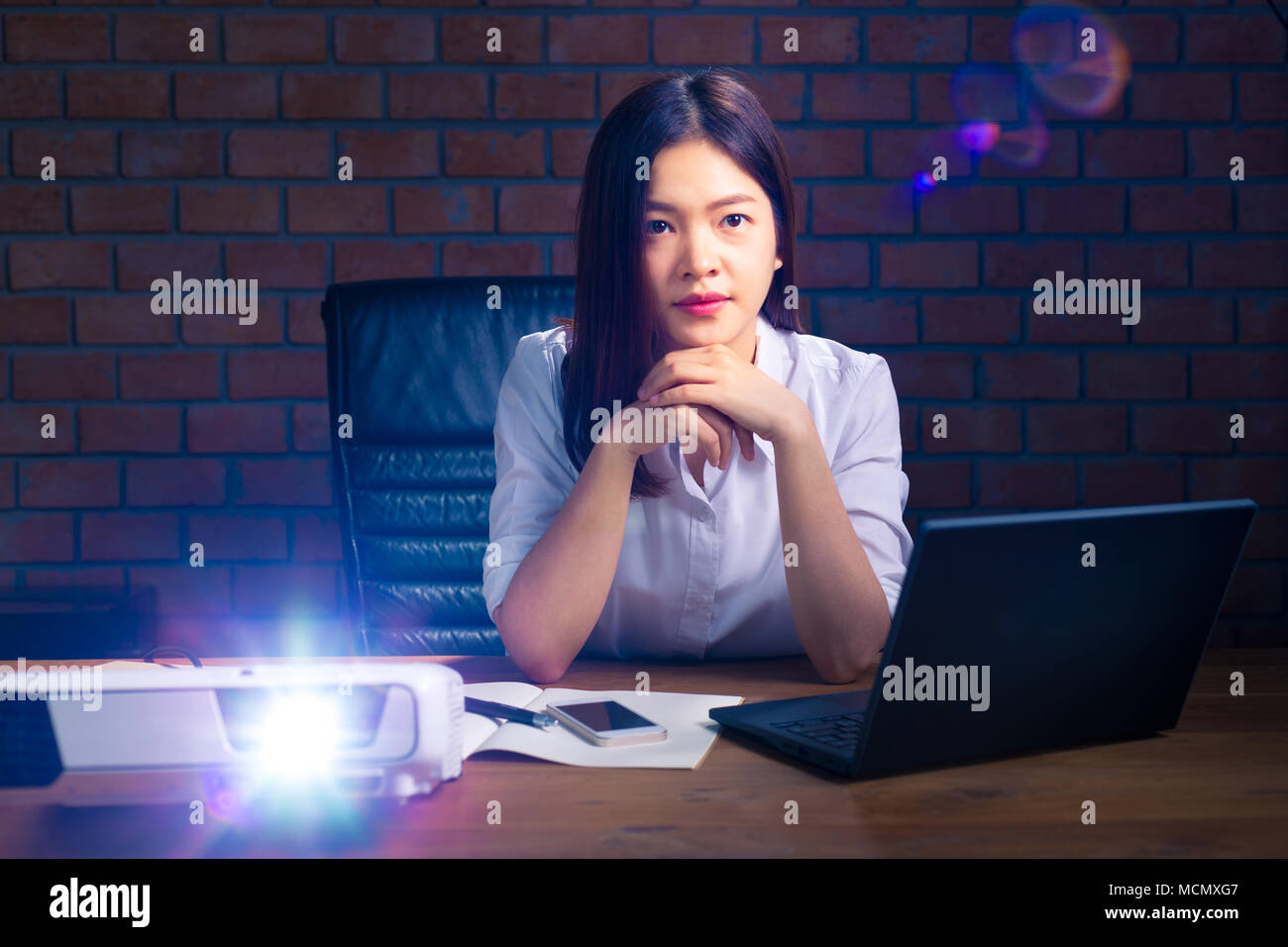 Young attractive and successful asian executive woman watching ...