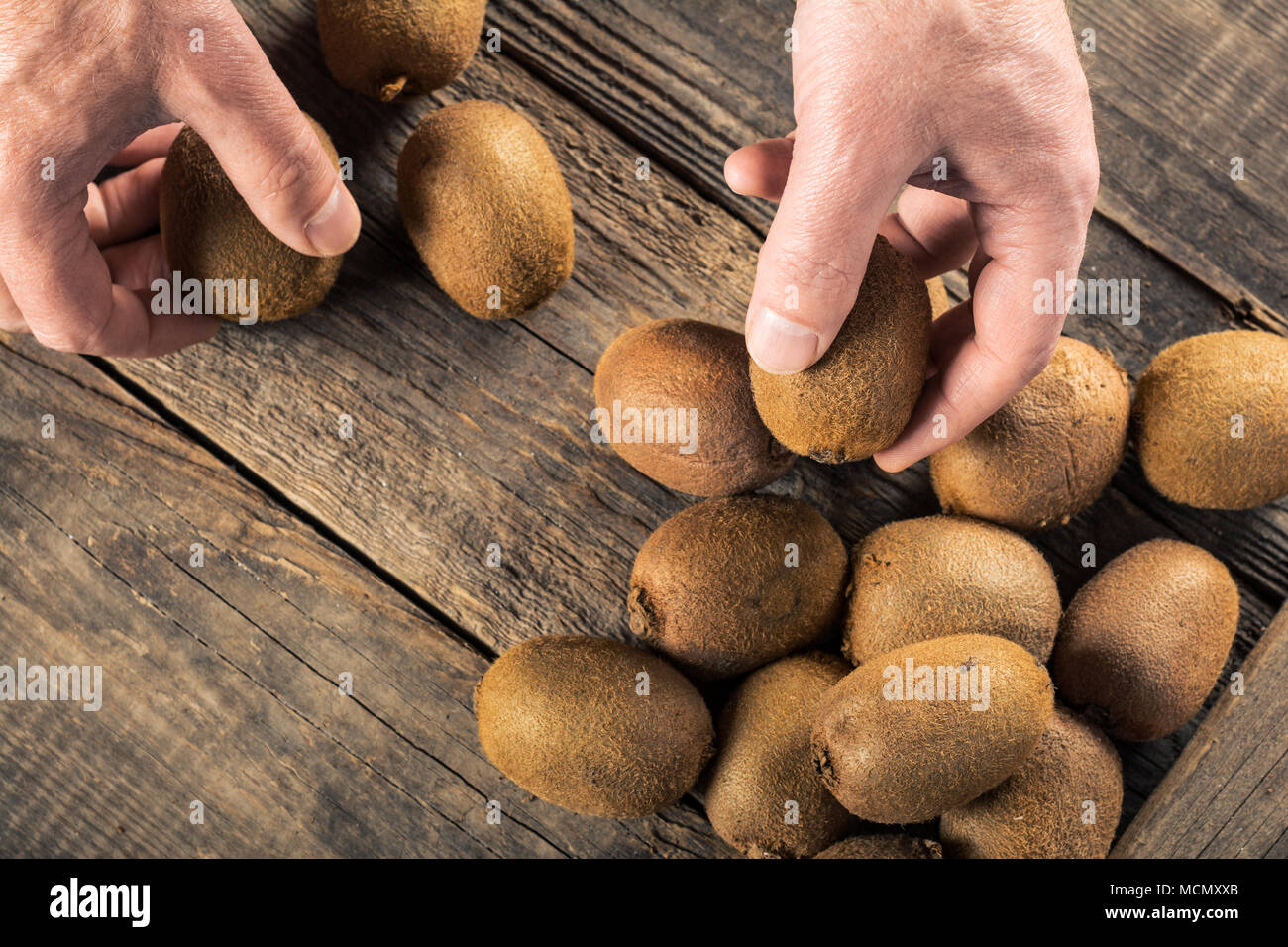 Kiwi fruits in hands Stock Photo - Alamy