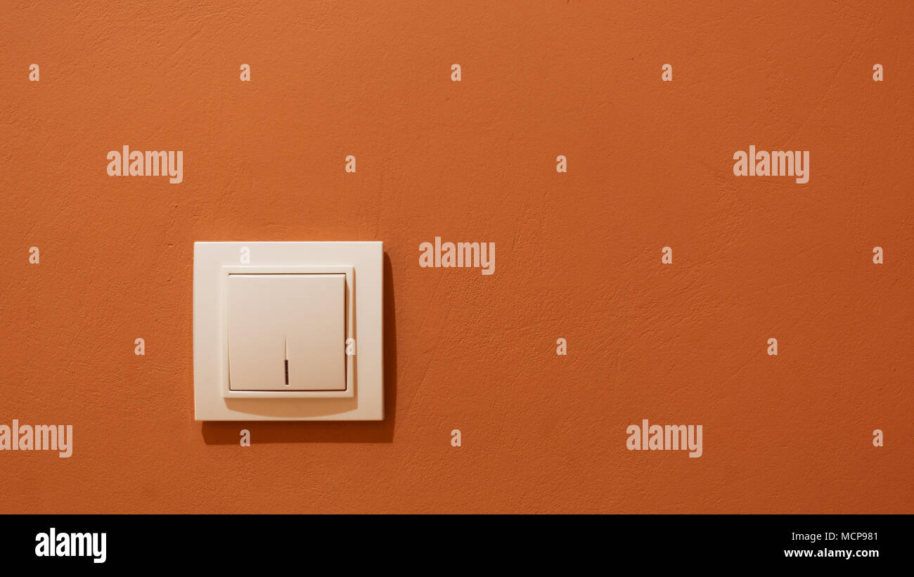 White switch button on the wall. Electrical light switch on the wall ...