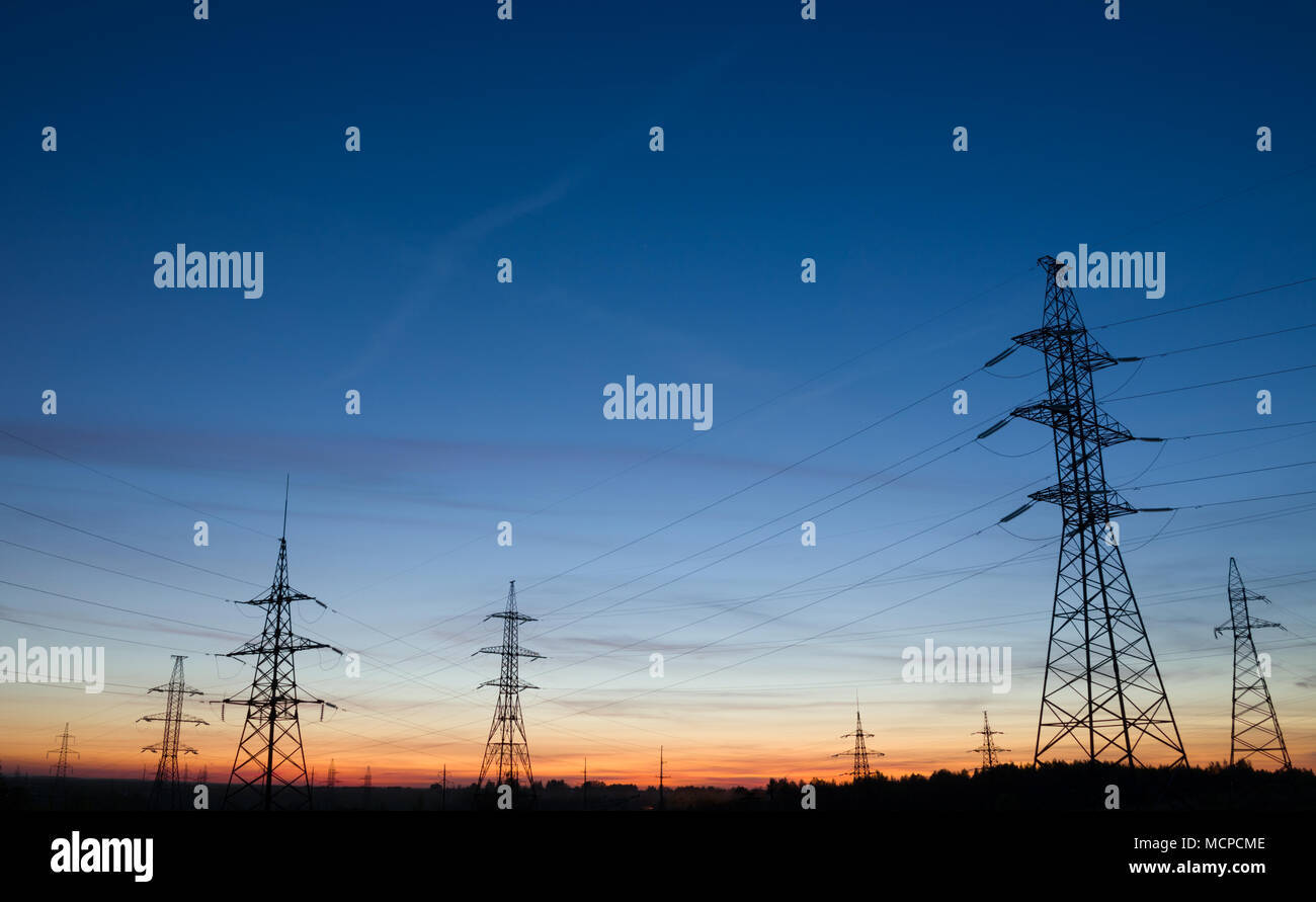 High voltage electricity pylons at beautiful sunset. Electric pole ...